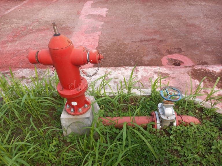 The Red Fire Hydrant is Connected To a Pipe with a Valve To Regulate it ...