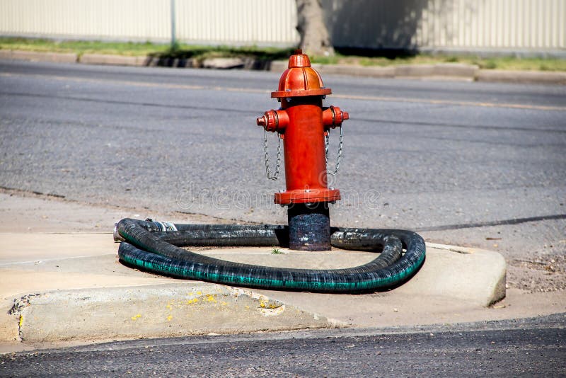 Red Fire Hydrant with Fire Hose Wrapped Around it on Corner of Street ...