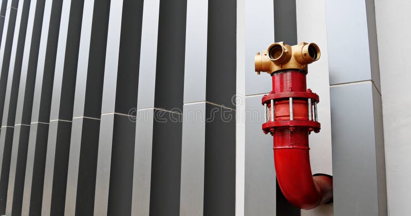 The Red Fire Hydrant Outside the Building is Decorated in a Modern ...