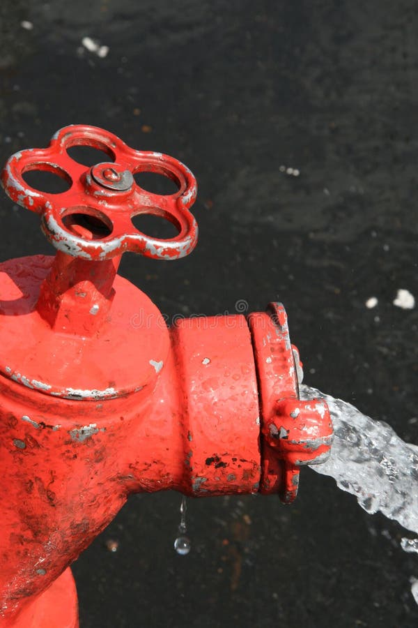 Red fire hydrant and water stock photo. Image of hydrant - 5241164