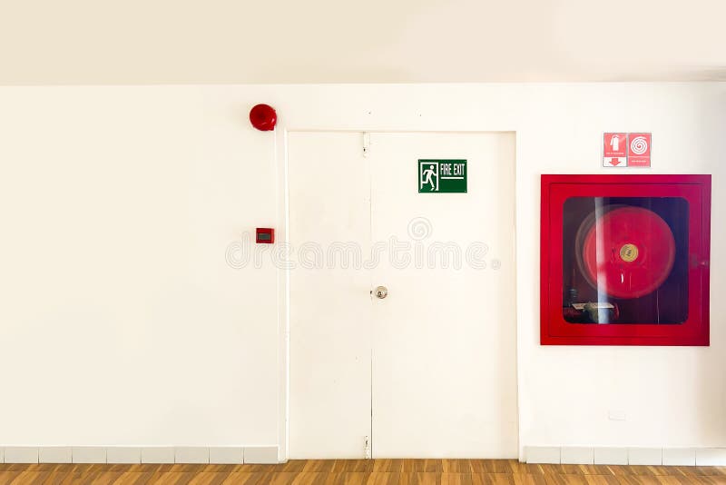 Red Fire Safety Equipment Set on Wall with Exit Door Stock Photo ...