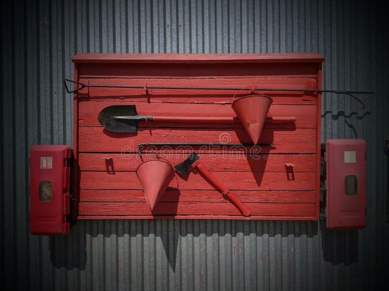 A Red Fire Shield with a Tool Hanging on it for Firefighters Stock ...