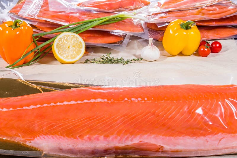 Red Fish in a Sealed Vacuum Plastic Bag on the Background of a Stack of ...