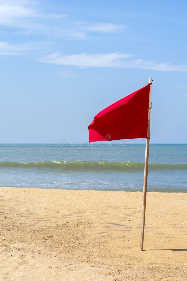 Red Flag on the Beach with a Very Calm Ocean Stock Photo - Image of ...