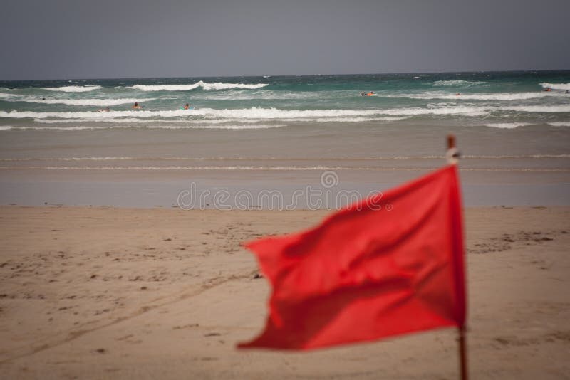 Red flag flap on the beach stock image. Image of travel - 99641123