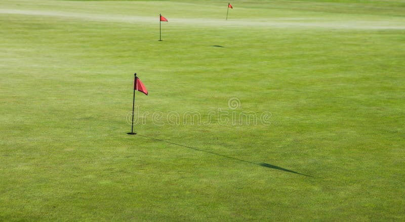 A Red Flag in the Hole on the Golf Course Stock Photo - Image of ...
