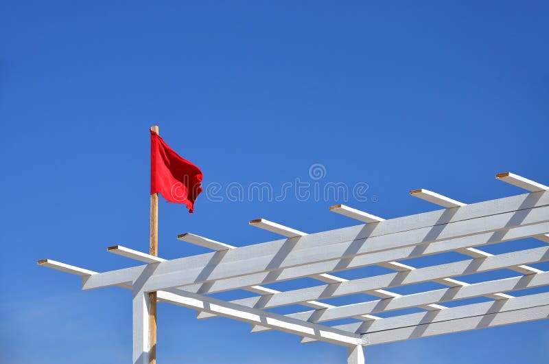 A Red Flag Indicating a Strong Wind on the Beach and the Sea is Flying ...