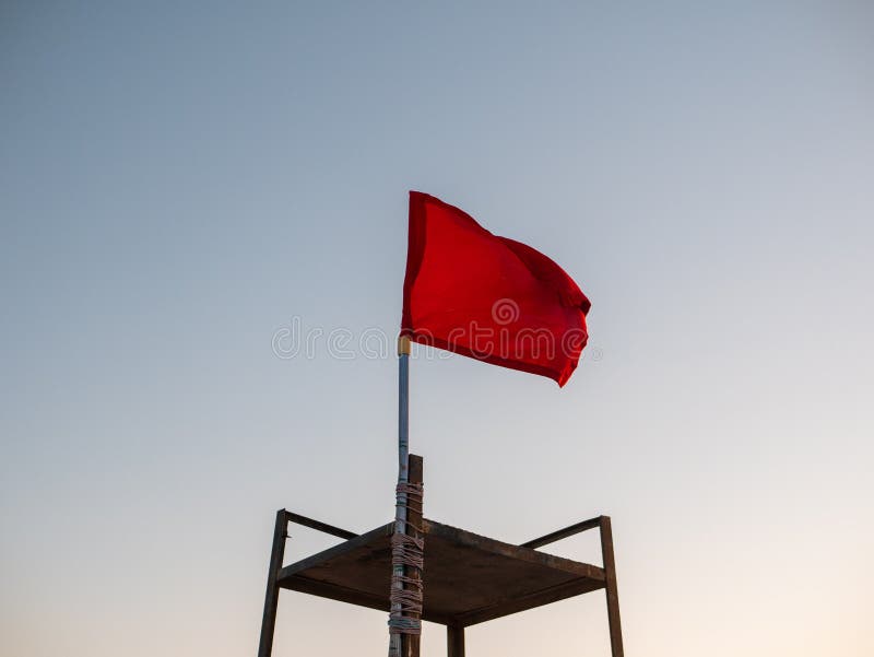 The Red Flag is Installed on the Lifeguard`s Tower and Flies in the ...