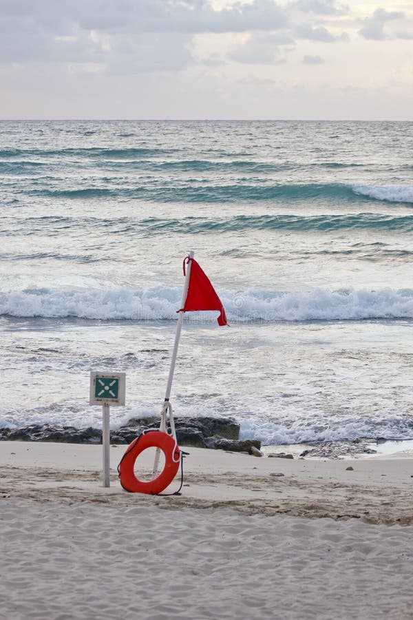Red Flag and Orange Life Ring on Beach at Dawn Stock Image - Image of ...