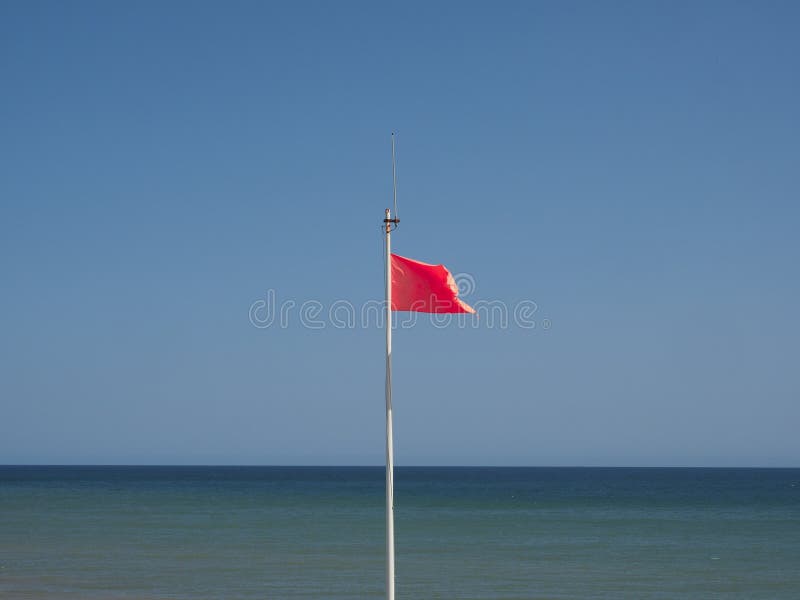 Red flag at sea stock photo. Image of blue, water, flag - 281757594