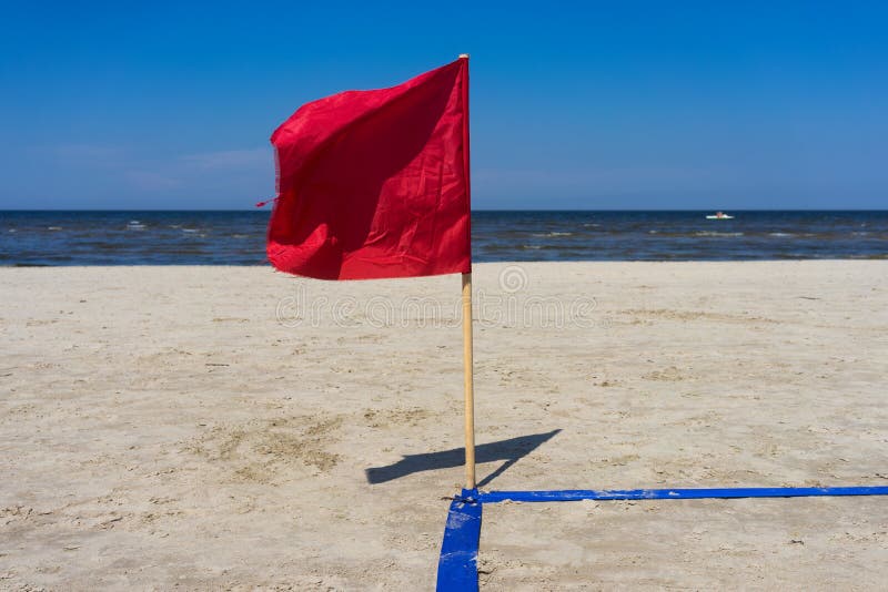 Red Flag in the Wind on the Sandy Beach Stock Image - Image of sign ...