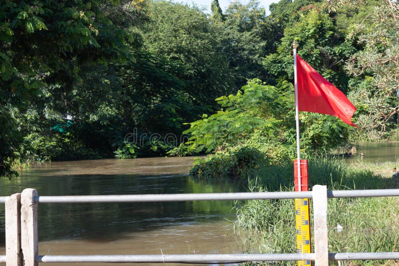 Red Flag and Yellow Water Level Indicator in River Stock Photo - Image ...
