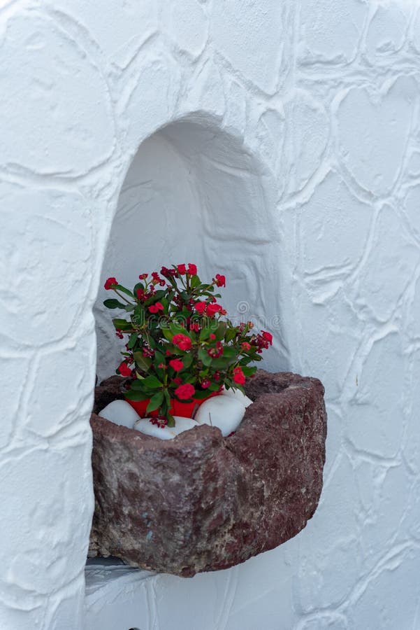 Red flowers in a stone pot stock image. Image of decoration - 203576027