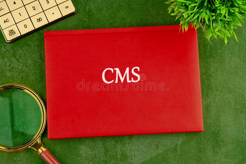 Red Folder with CMS Abbreviation Displayed Prominently on a Green ...