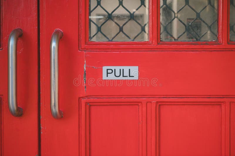 A Red Front Door with Handles and Pull Sing Stock Photo - Image of ...
