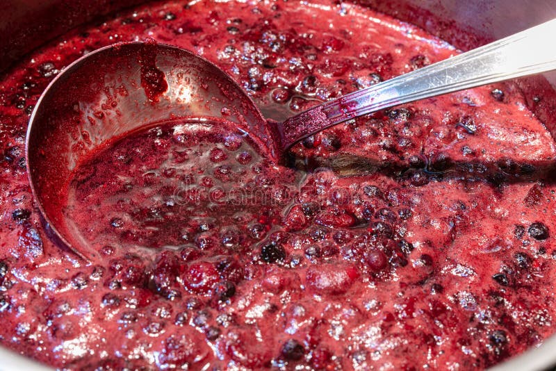 Red fruit jam being cooked stock photo. Image of ladle - 196046770