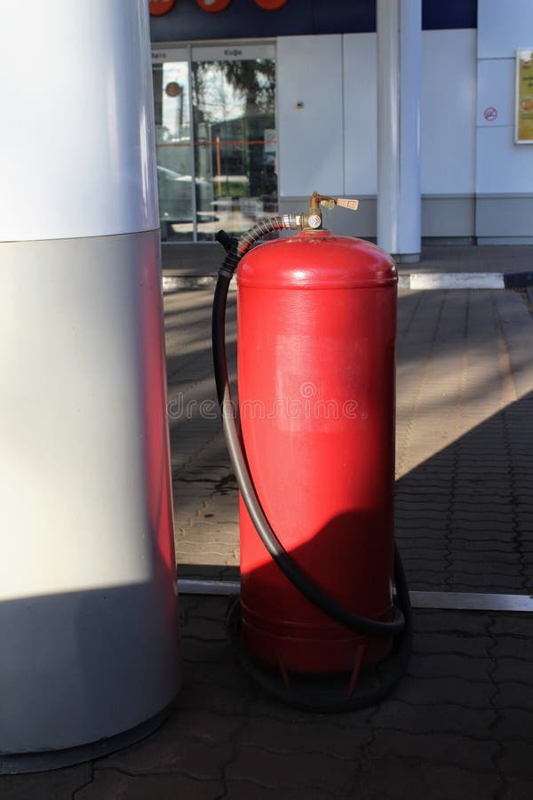 Red Gas Cylinder Standing on the Ground at the Gas Station Stock Photo ...