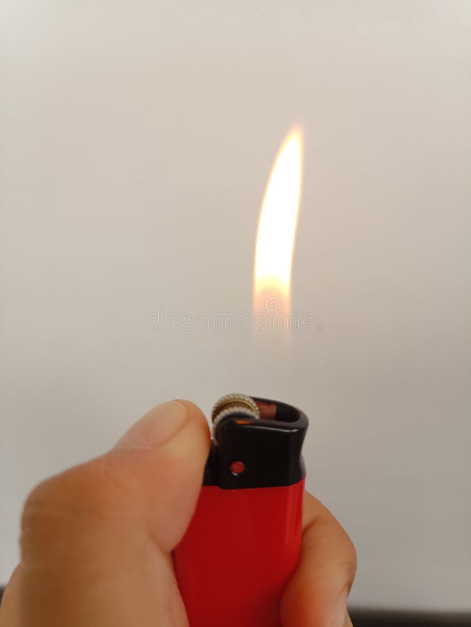 A Red Gas Lighter is Being Lit and Emitting Fire. Stock Image - Image ...