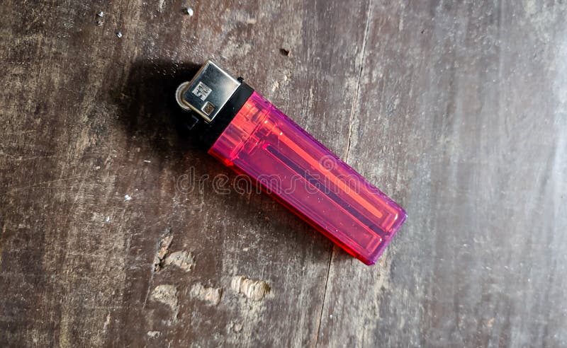 Red Gas Lighter Lying on the Wood Stock Photo - Image of abstracts ...