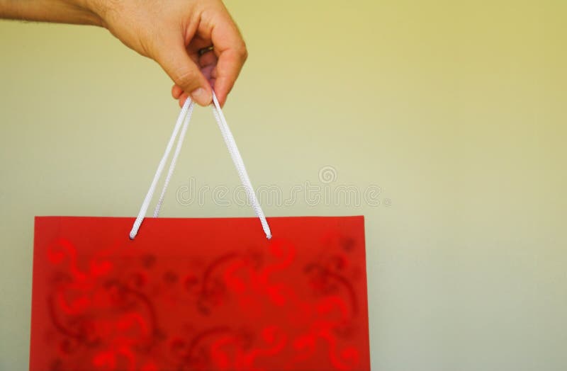 Red gift bag in man s hand stock image. Image of beige - 1898581