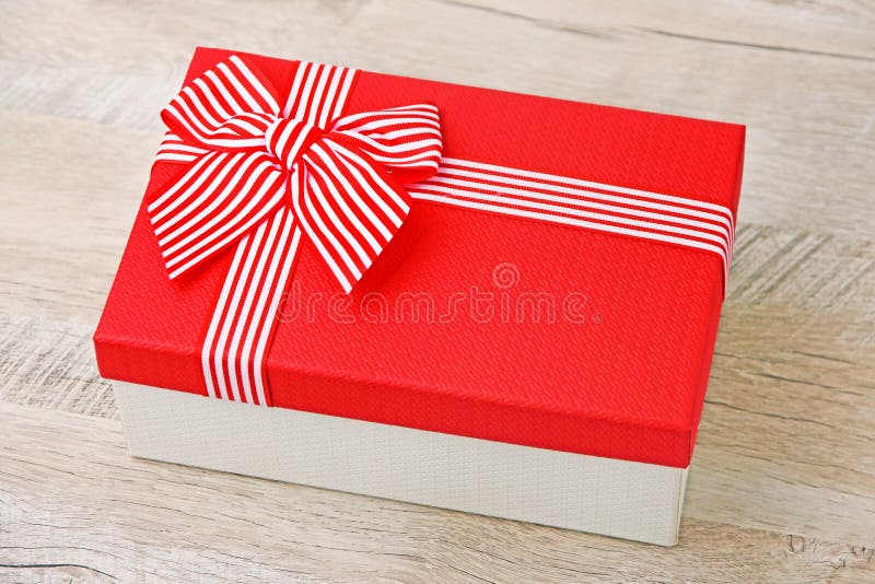 Red Gift Box with Bow on a Wooden Table Stock Image - Image of ...