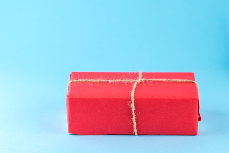 Red Gift Box Tied With String On A Bright Green Background, Minimalism ...