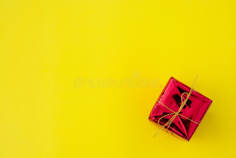 Red Gift Box with Yellow Ribbon on Yellow Background Stock Photo ...