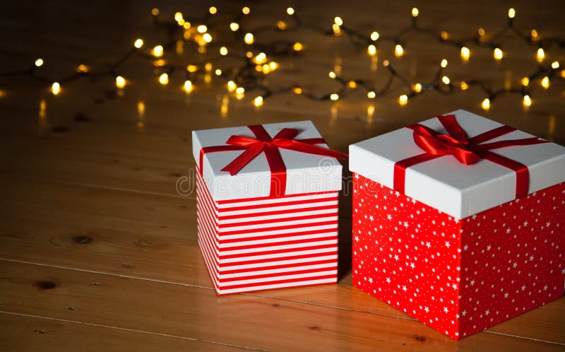 Red Gift Boxes and Christmas Lights on Wooden Floor Stock Photo - Image ...