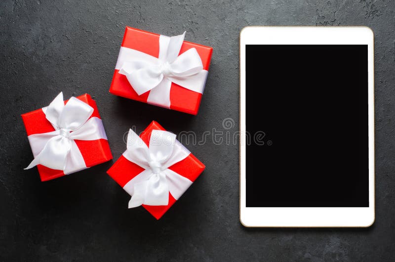 Red Gift Boxes and a Tablet with a Blank Screen for Text. Copy Space ...