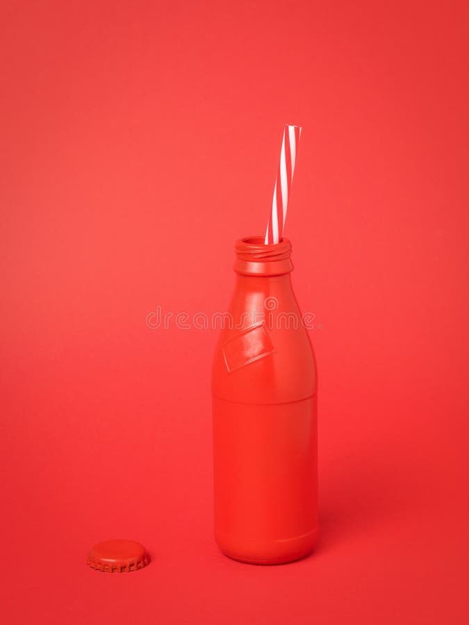 Red Glass Bottle with a Cocktail Tube on a Red Background Stock Photo ...