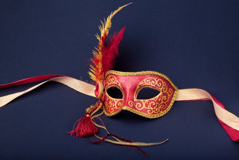 A Red and Gold Feathered Venetian Mask on Red Background Stock Image ...