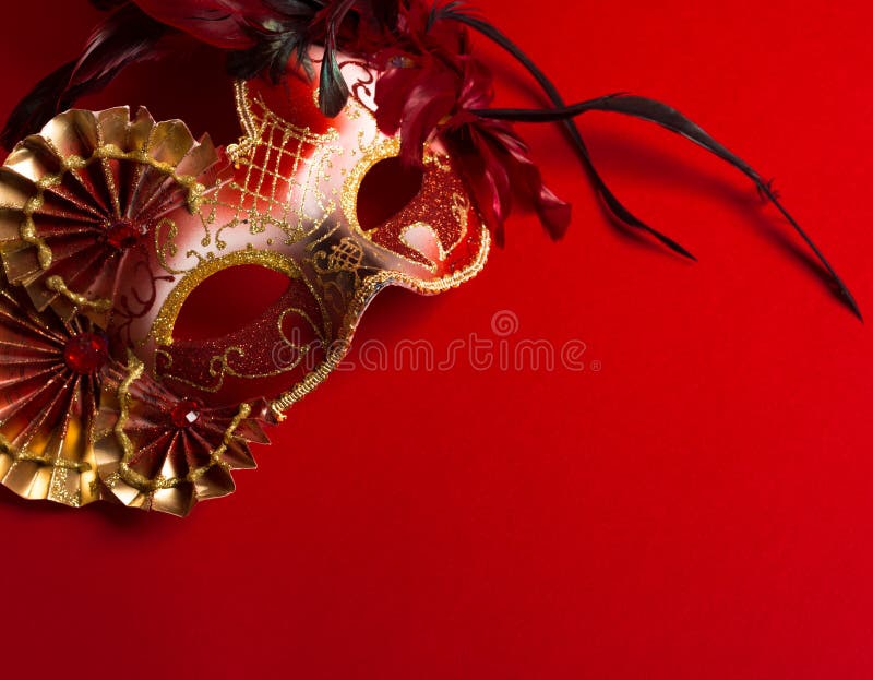 A Red and Gold Feathered Venetian Mask on Red Background Stock Image ...