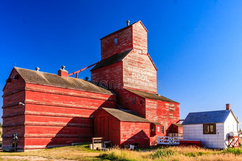 A Red Grain Silo with a White House in the Background Stock Photo ...