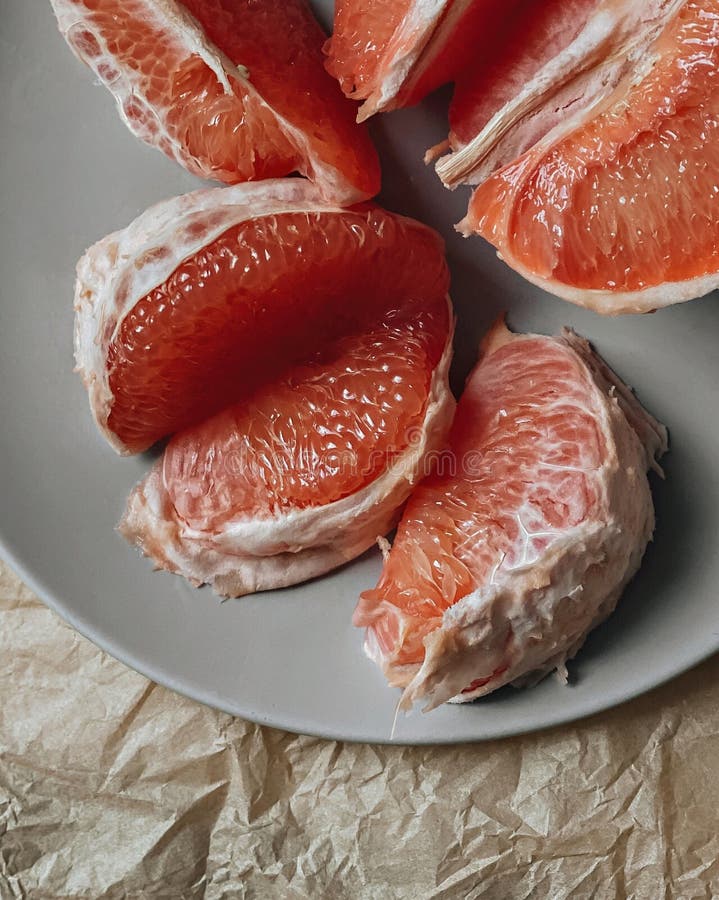Red Grapefruit Slices on a Gray Plate. Shallow Dof. Stock Image - Image ...