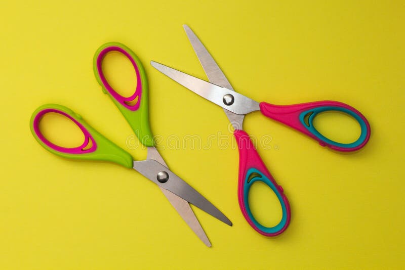 Red and Green Baby Scissors Isolated on a Yellow Background Stock Photo ...