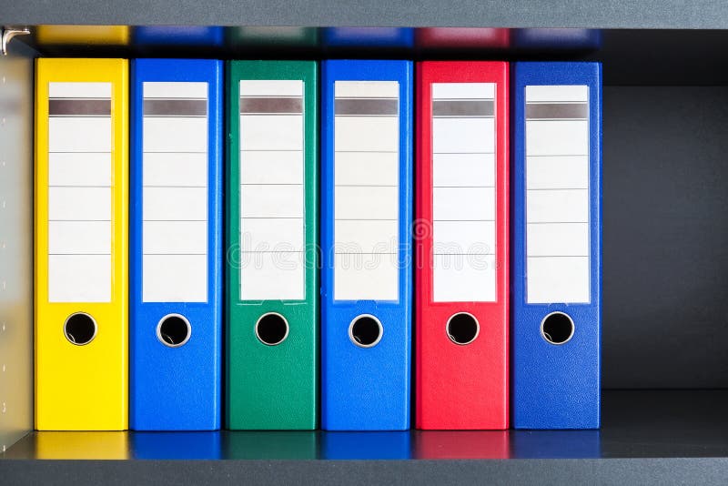 Stacked Red, Green, Blue and Yellow Office Folders Stock Image - Image ...