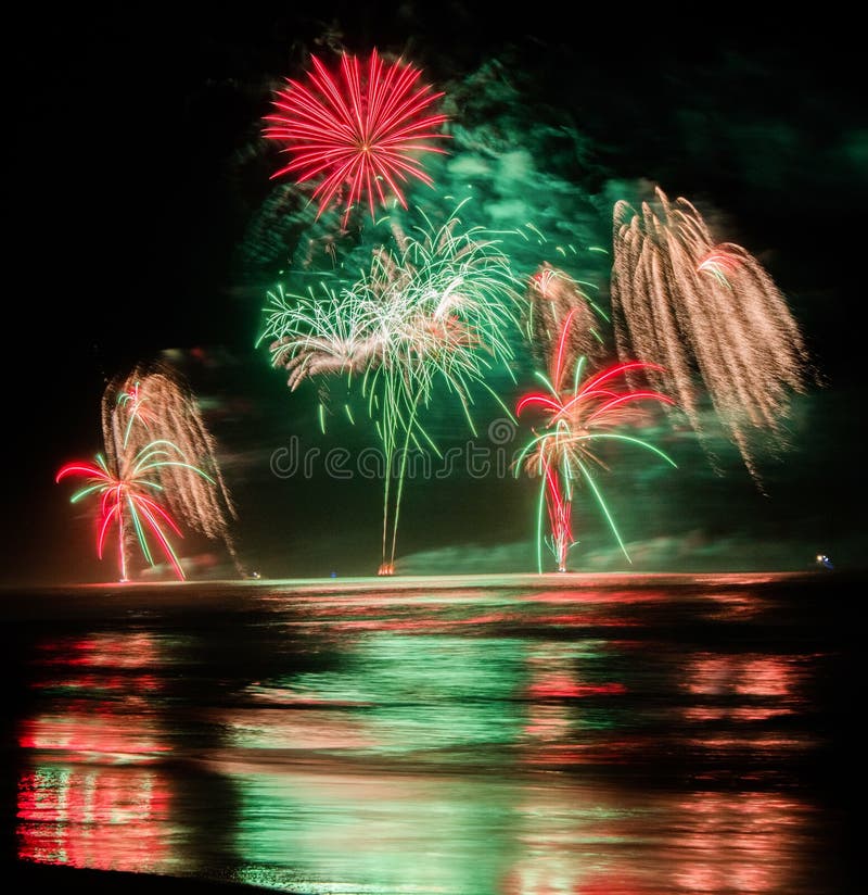 Red and Green Fireworks Exploding Over the Ocean Stock Image - Image of ...