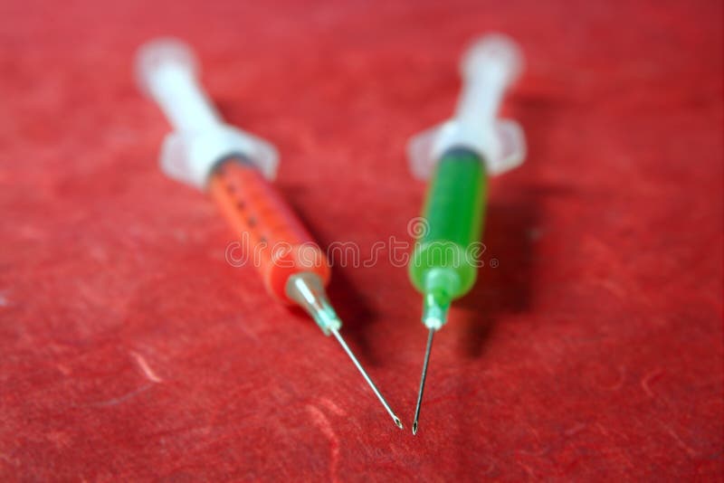 Red and Green Syringe Over Red Background Stock Photo - Image of close ...
