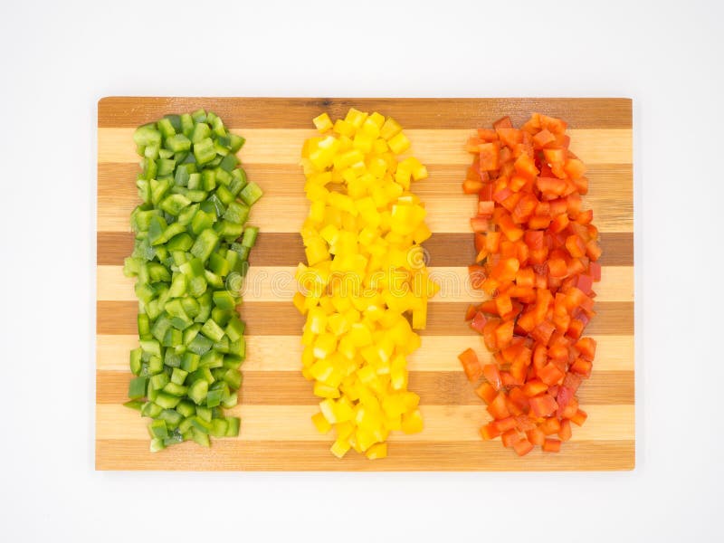 Red, Green and Yellow Sweet Bell Peppers Chopped on a Wooden Cutting ... Red, Green and Yellow Sweet Bell Peppers Chopped on a Wooden Cutting ...