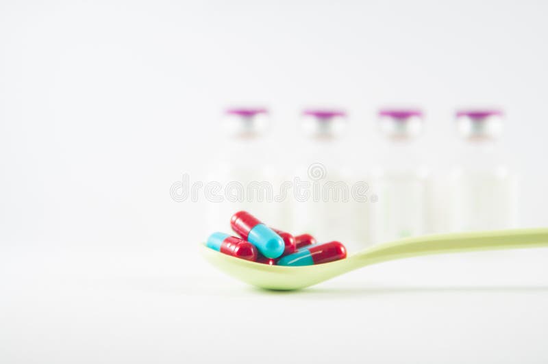 Red and Grey Capsule in Spoon Stock Image - Image of health, pill: 41551055