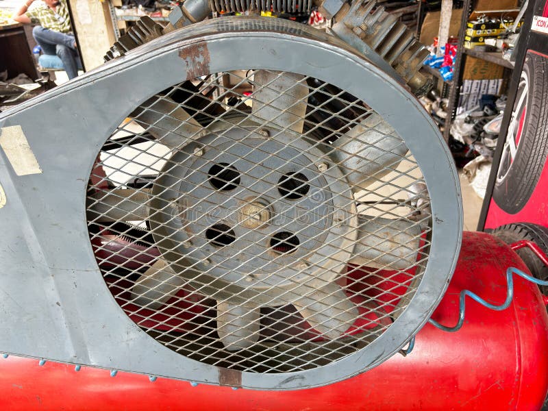 A Red and Grey Machine, Air Compressor with a Fan on it Stock Photo ...