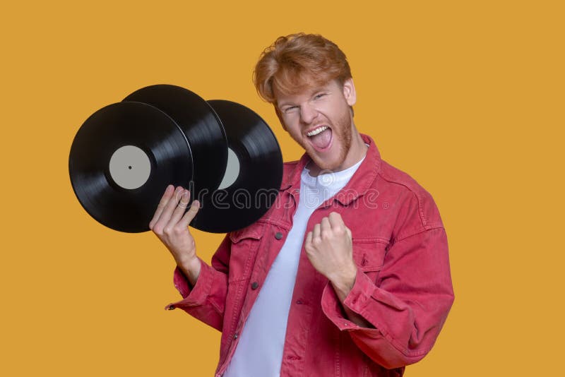 Red-haired Bearded Young Man in Red Jacket with a Record Feeling ...