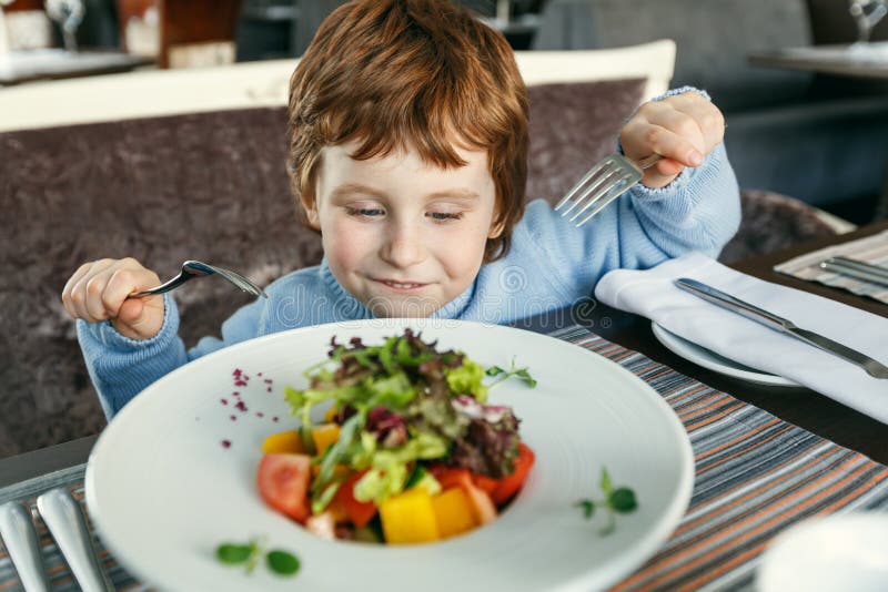 Red Haired Boy with Forks Eating Salad Stock Image - Image of sign ...