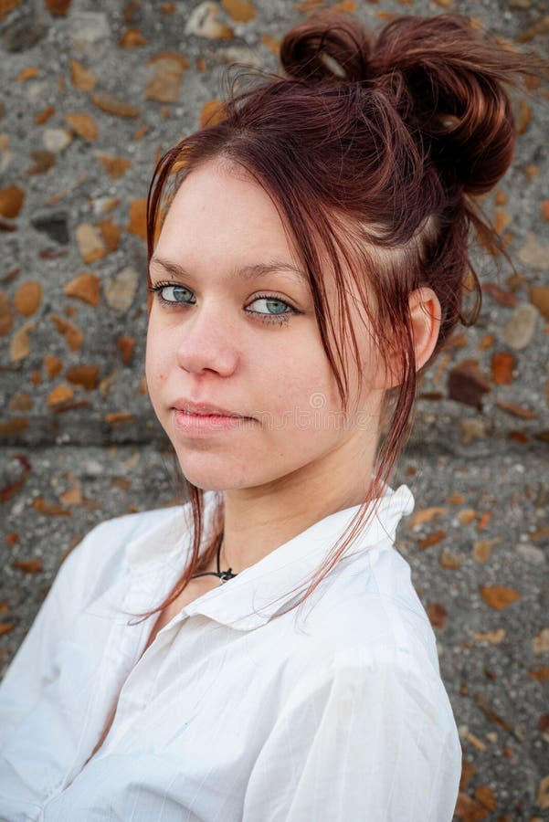 Red-haired Girl in a Formal Outfit Standing in Front of a Stone Wall ...