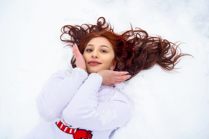 Red Haired Girl is Lying in the Snow Stock Photo - Image of face, cute ...