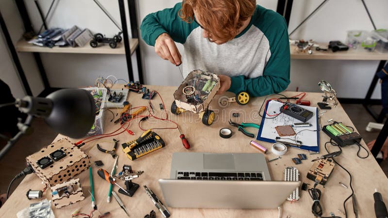 Red Haired Male it Engineer Fix Broken Wheel Robot Stock Photo - Image ...