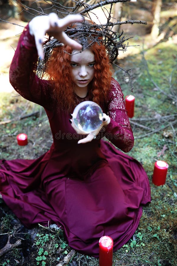 The Red-haired Witch Holds a Ritual with a Crystal Ball Stock Photo ...