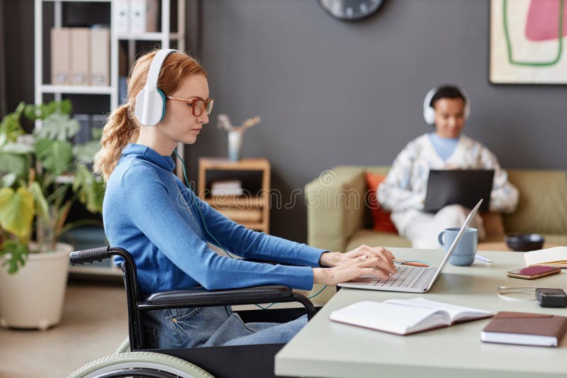 Red Haired Young Woman with Disability Using Computer Working in it ...