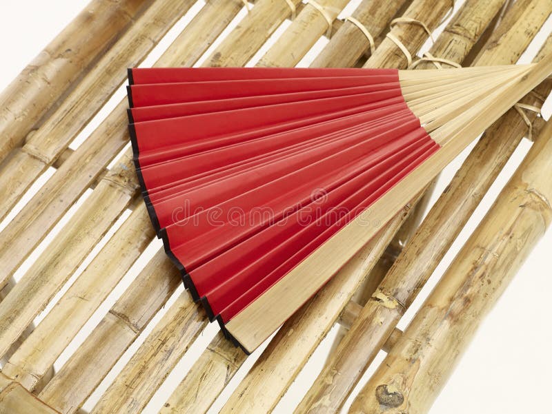 Red Hand Fan on Bamboo Bench Stock Photo - Image of umbrella, wood: 7245018