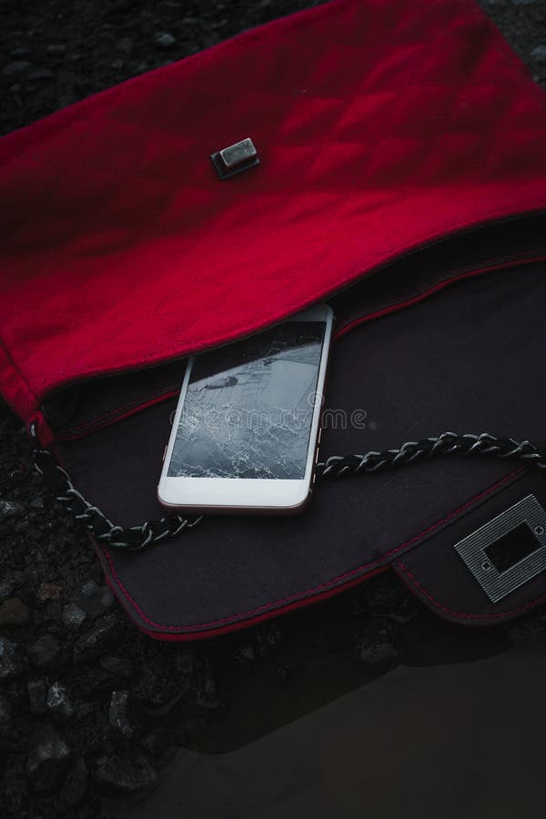 Red Handbag on the Ground. Mobile Phone Falling Out with Cracked and ...